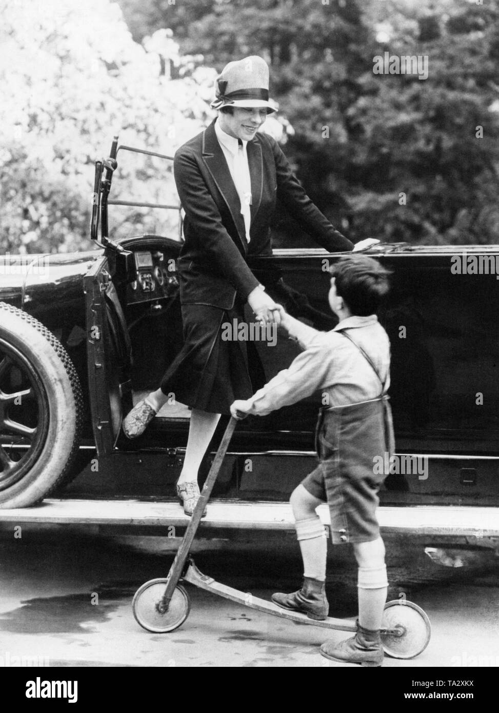 Woman getting on a scooter hi-res stock photography and images - Alamy