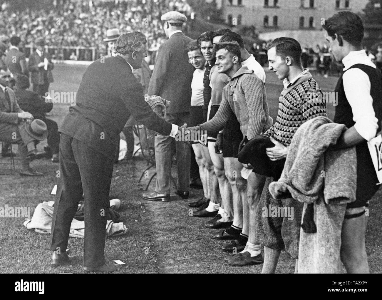The German cyclist Walter Ruett congratulates the participants of an ...