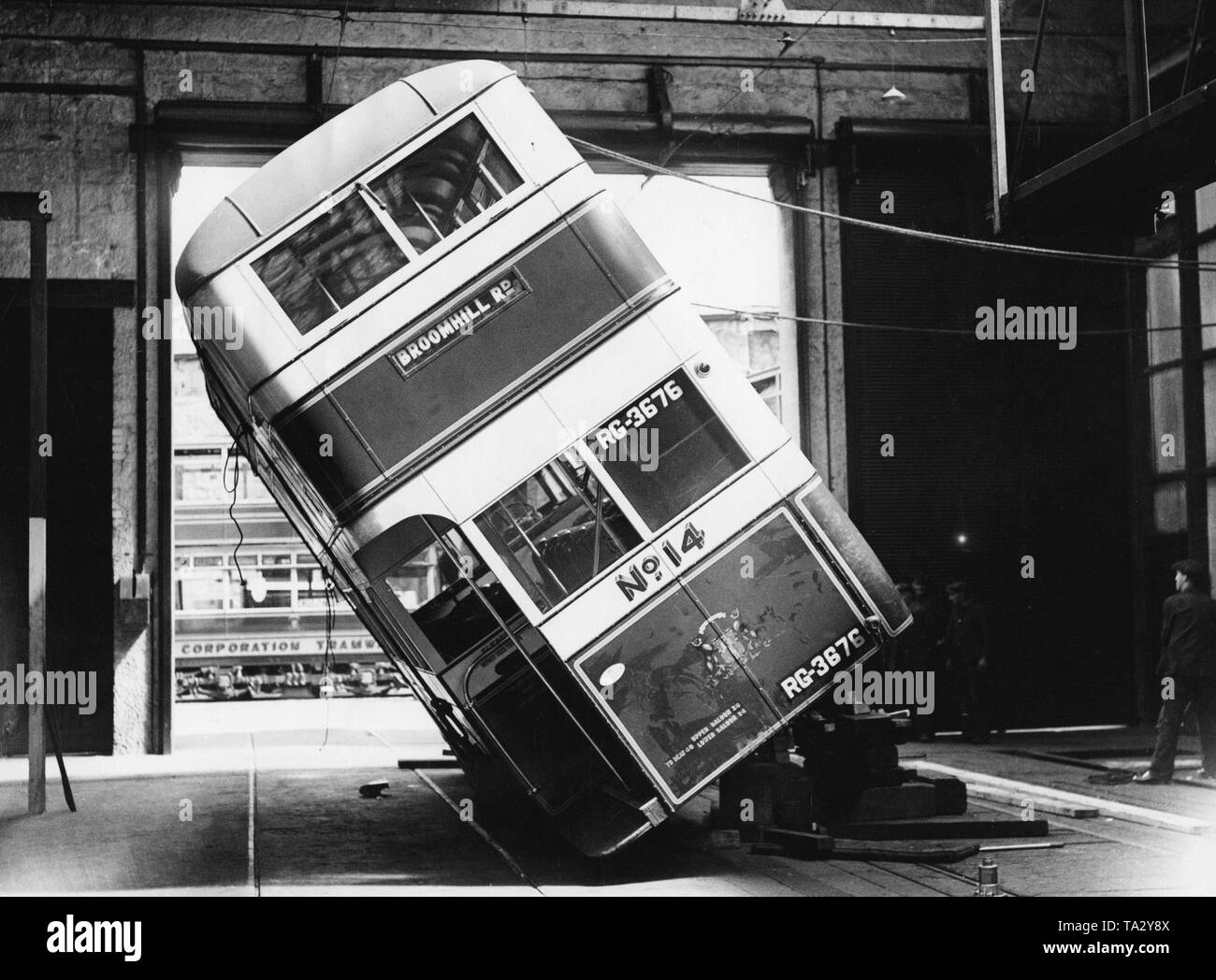 An English double-decker bus during a balance test Stock Photo - Alamy