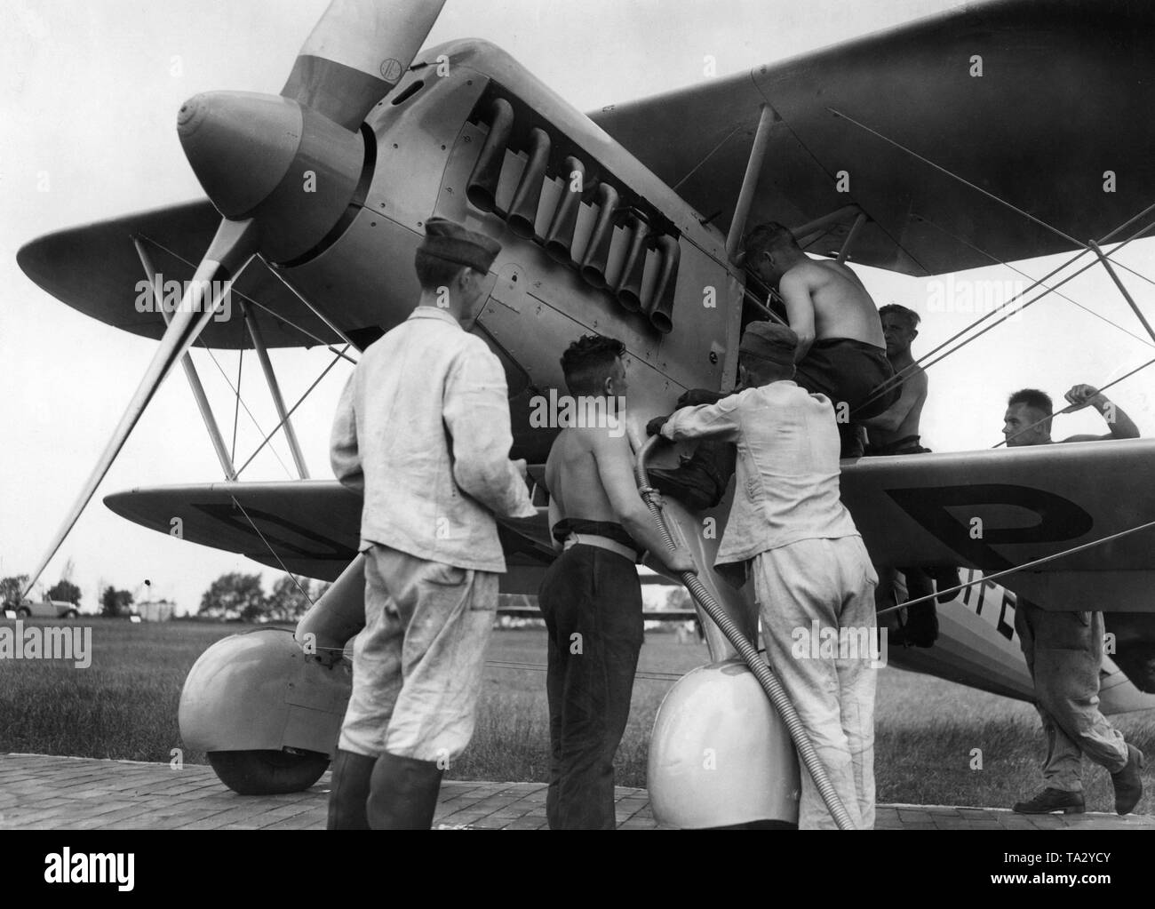 An aircraft of the type Heinkel 51 is being refueled for a training ...
