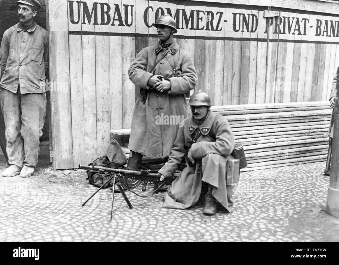 French soldiers keep guard with machine guns in front of a branch of ...