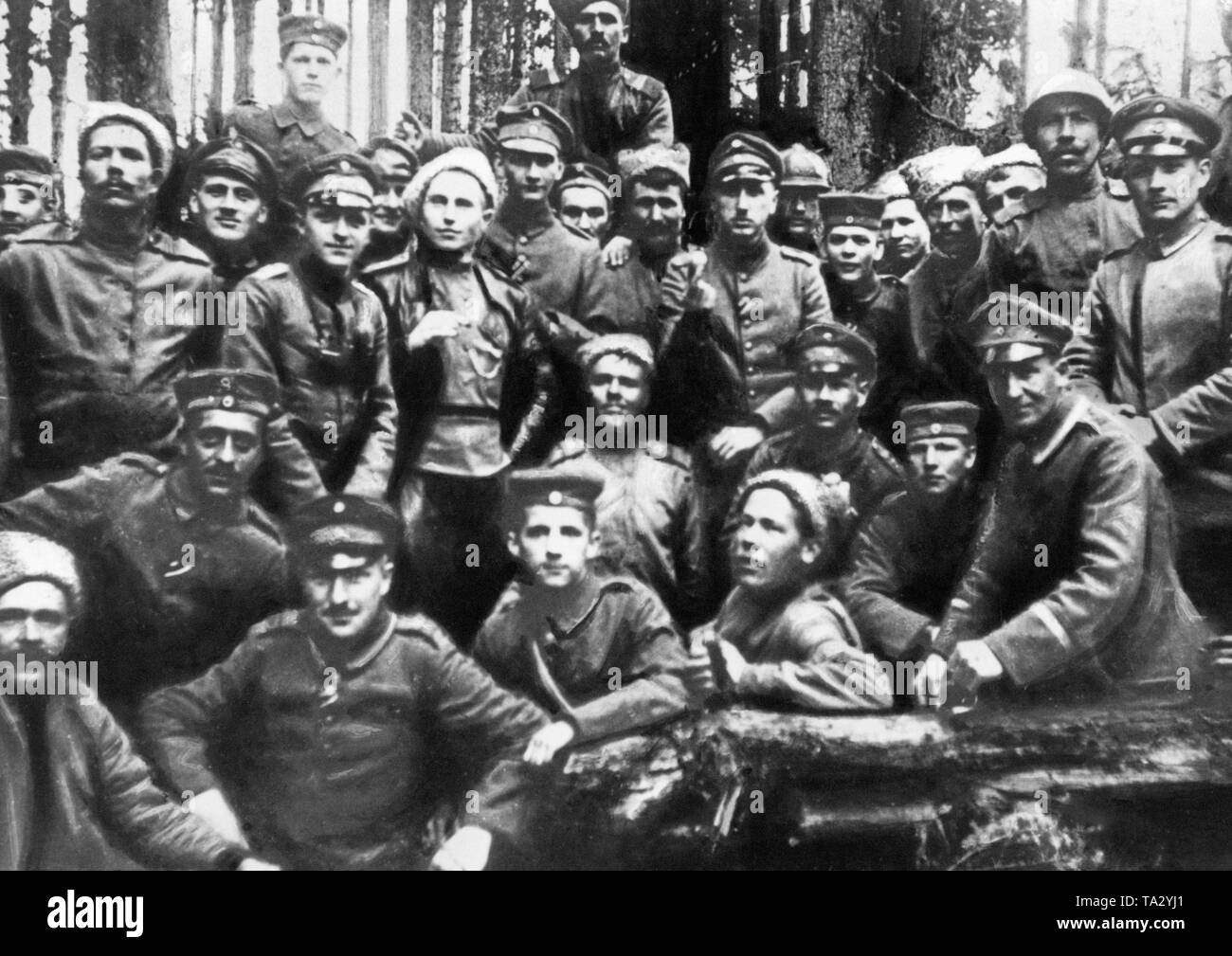 German and Russian soldiers pose between trenches. After Lenin's call ...