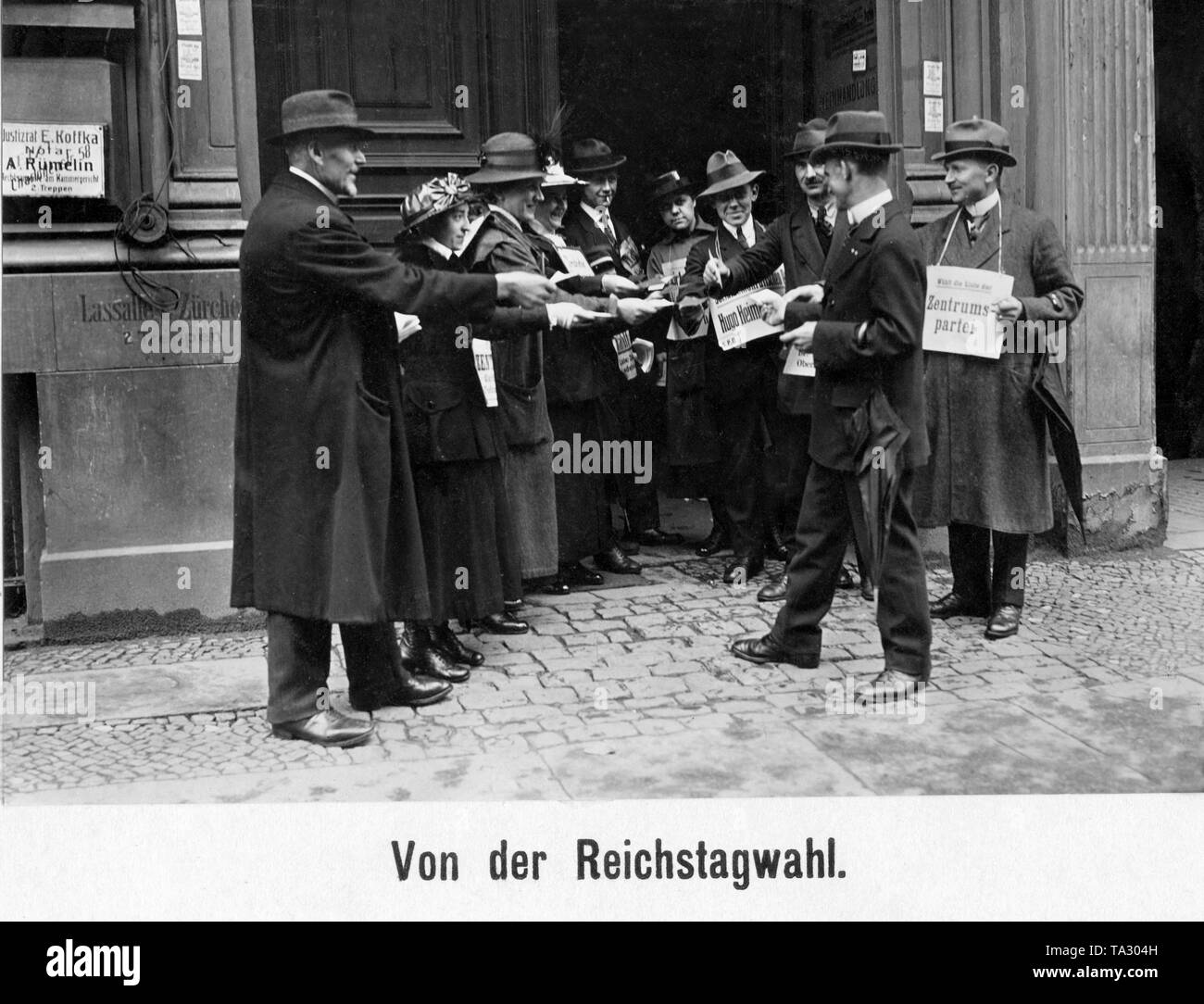 Representatives of the participating parties distribute brochures to a ...