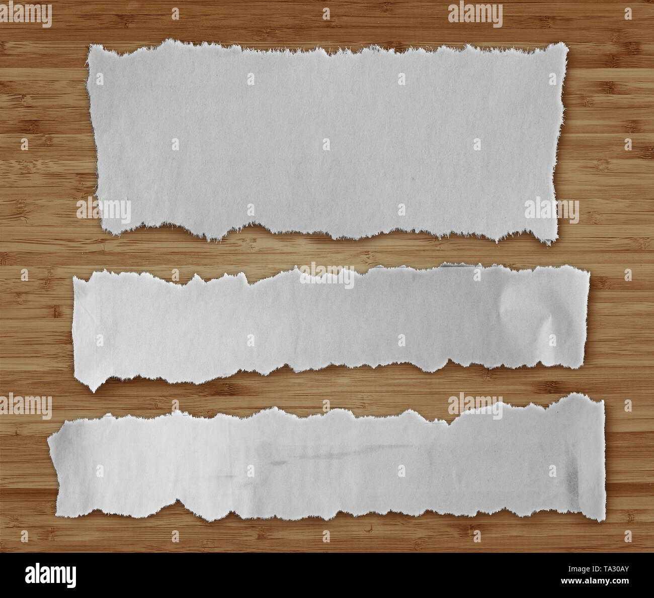 Three pieces of torn newspaper on wooden background Stock Photo - Alamy