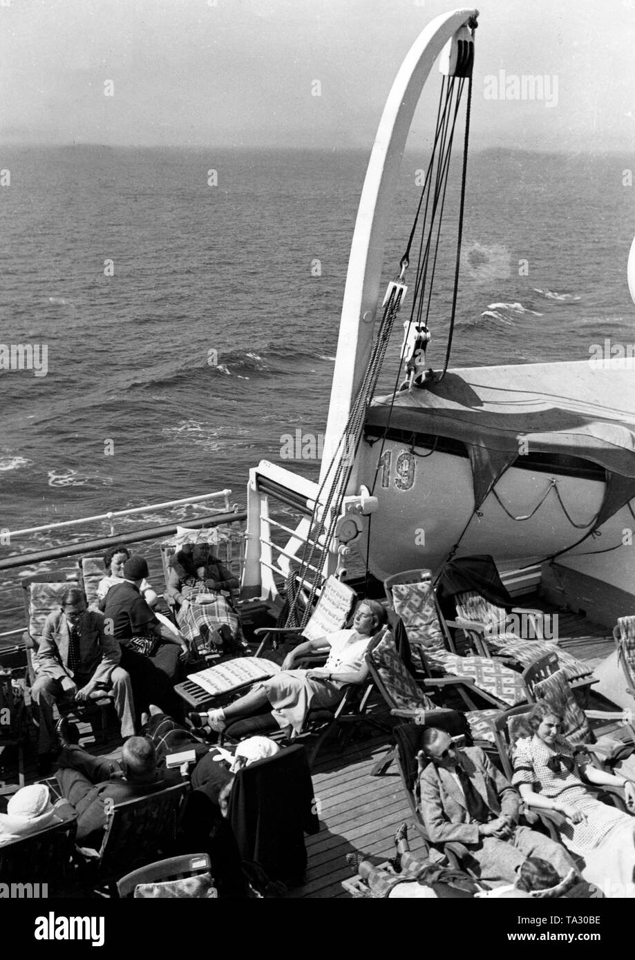 Vacationers are sunbathing on board a cruise ship of the Nazi ...