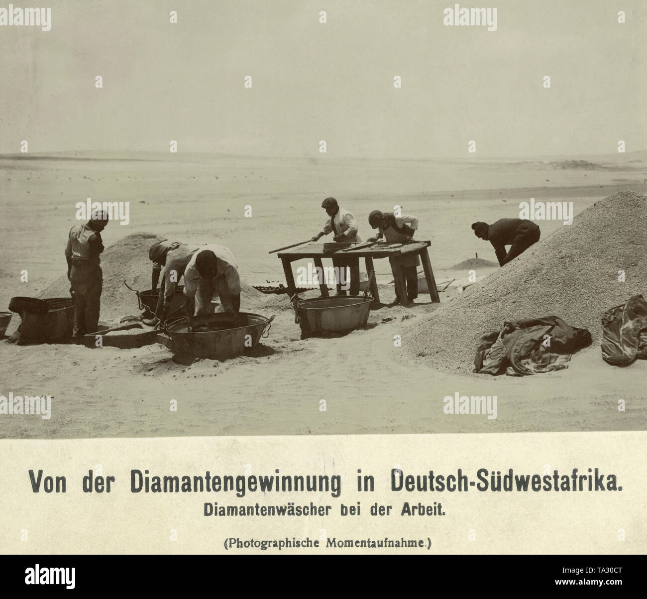 Workers in a diamond washing plant in the desert Stock Photo - Alamy