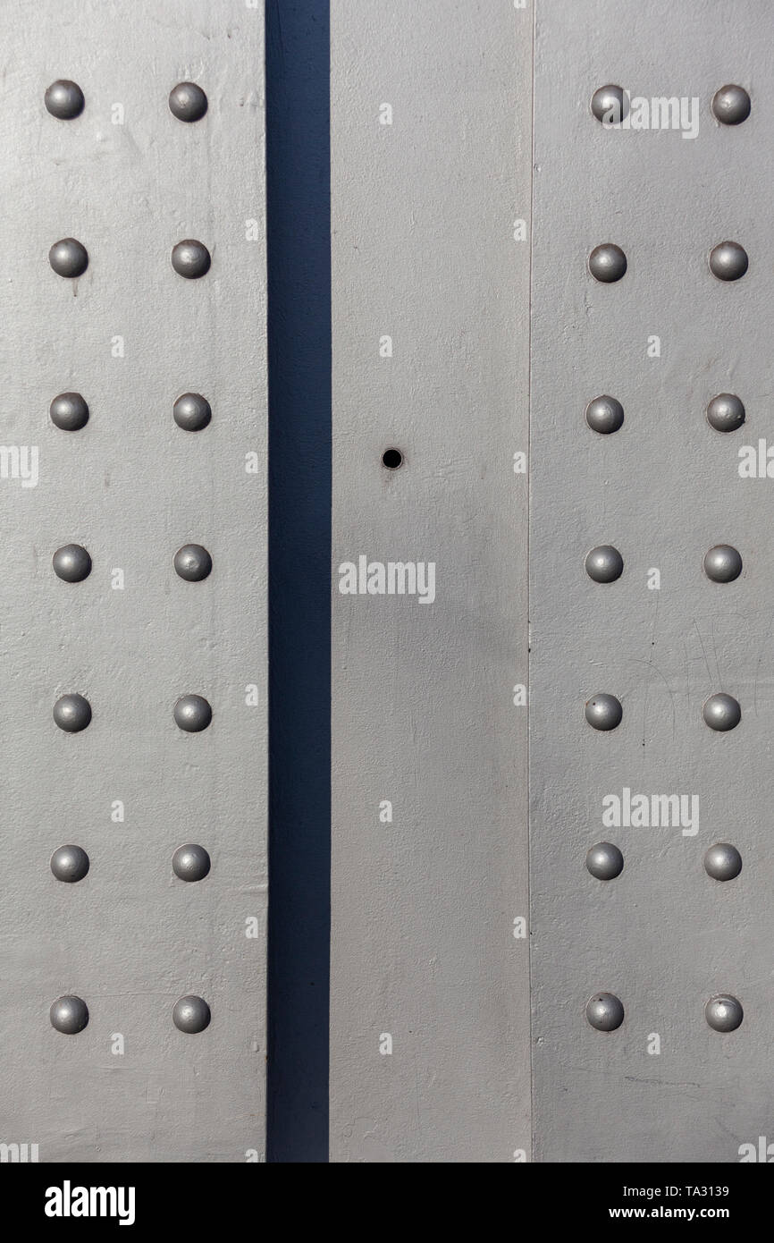 Grey rivets on a metal structure painted in grey Stock Photo - Alamy
