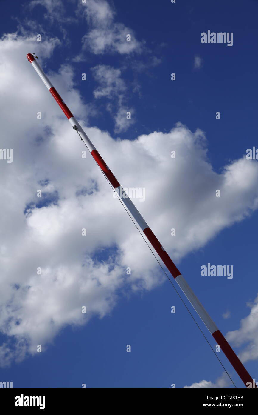 Red and white long pole pointing into the sky Stock Photo - Alamy