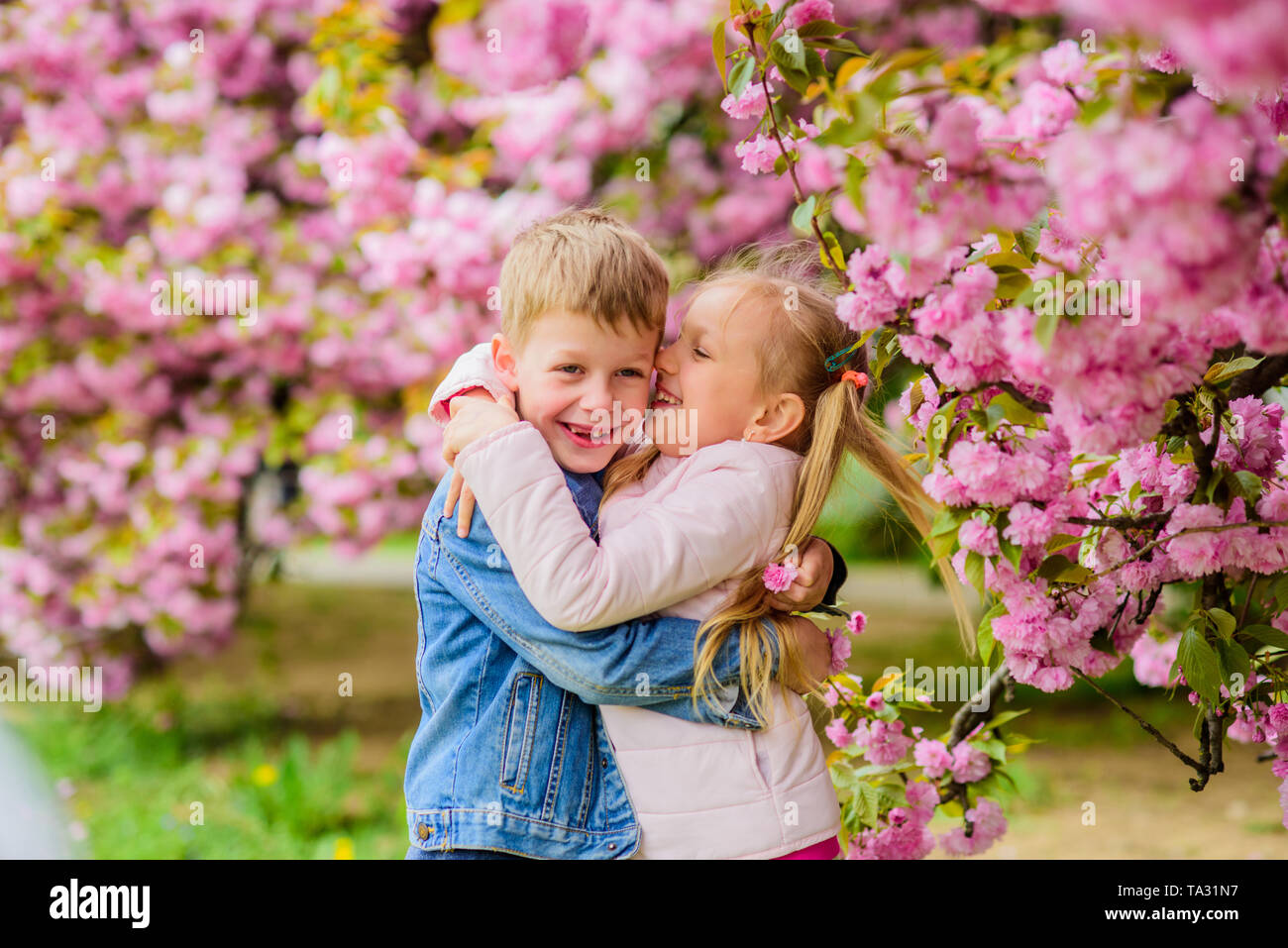 Little girl enjoy spring flowers. Giving all flowers to her. Surprising ...