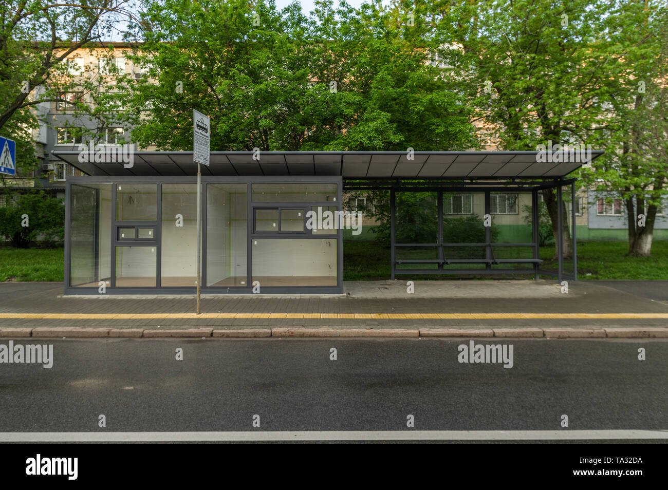 Bus stop with glass windows. Stop by the road Stock Photo - Alamy
