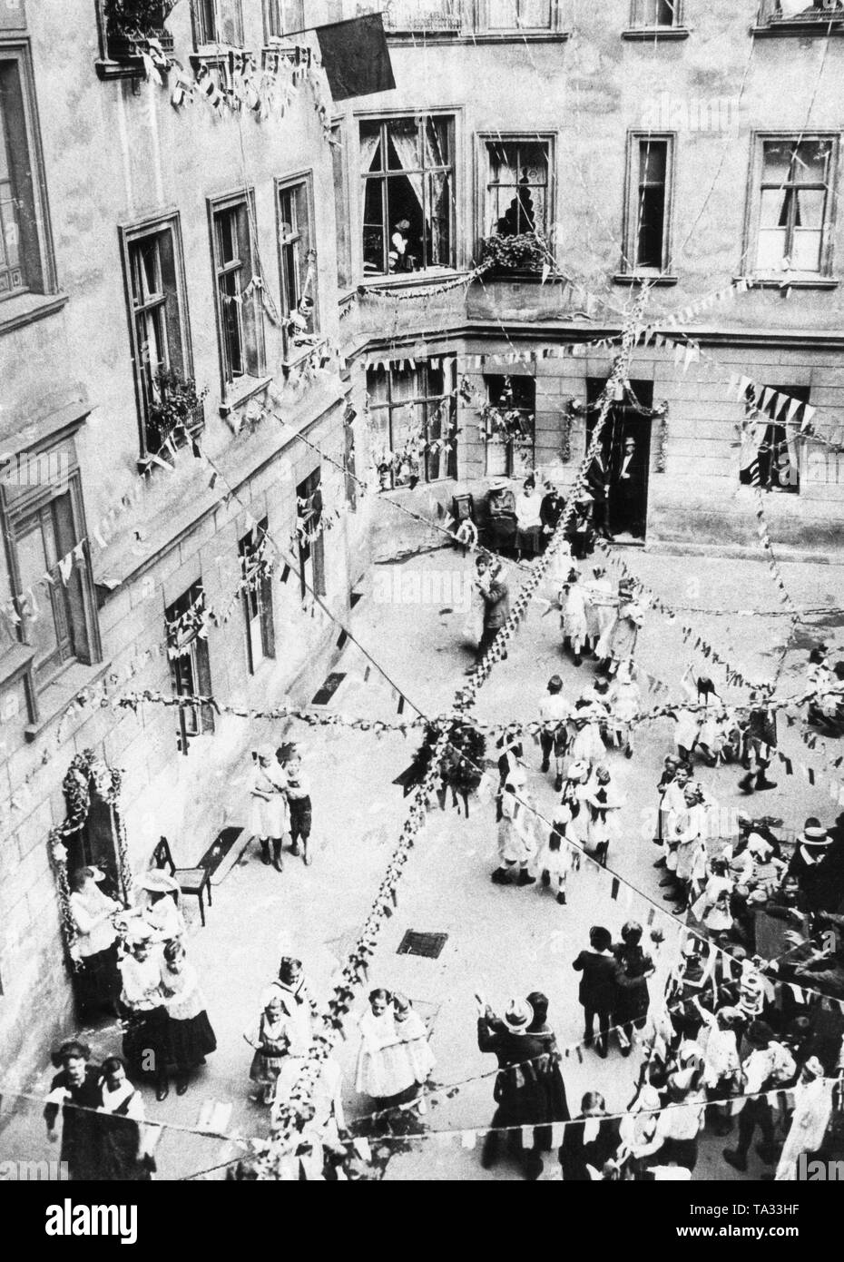 A small party is held in the backyard of a working-class district ...