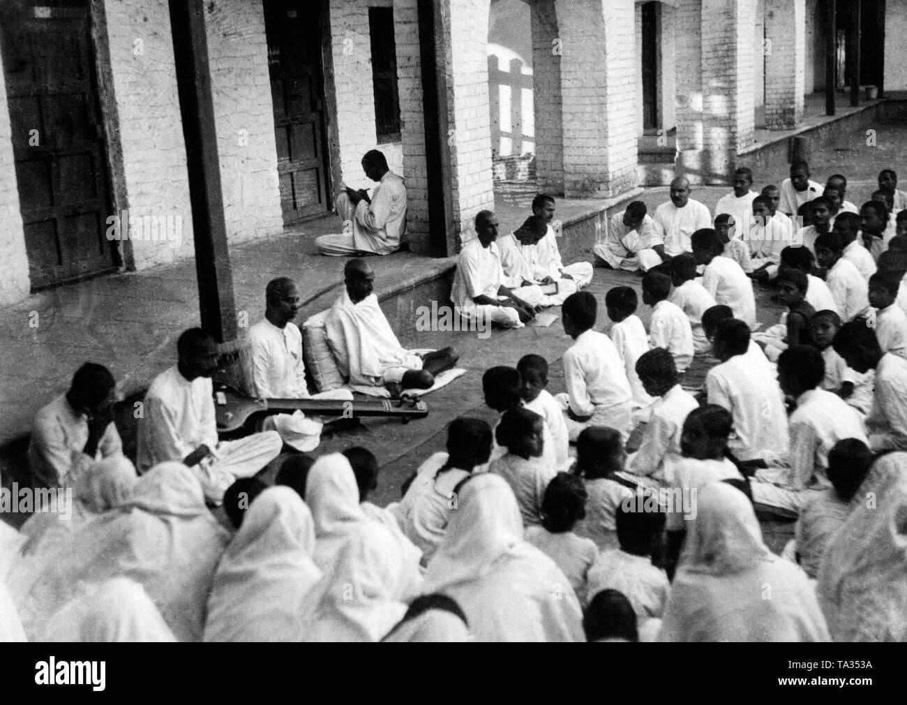 The Indian statesman Mahatma Gandhi (4th from left) giving a lecture in ...