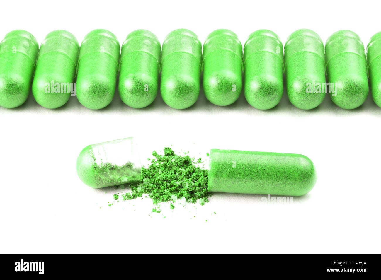row of ufo green color organic capsules isolated on white background ...