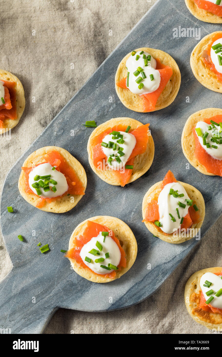 Homemade Smoked Salmon Cocktail Blinis with Creme and Chives Stock ...