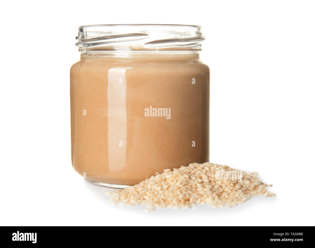 Jar of tasty tahini with sesame seeds on white background Stock Photo ...