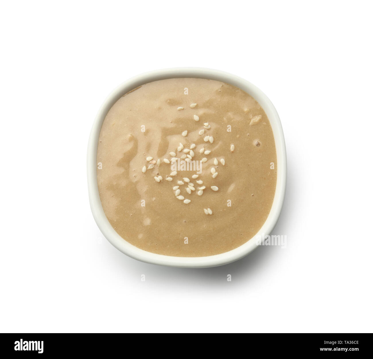 Bowl of tasty tahini on white background Stock Photo - Alamy