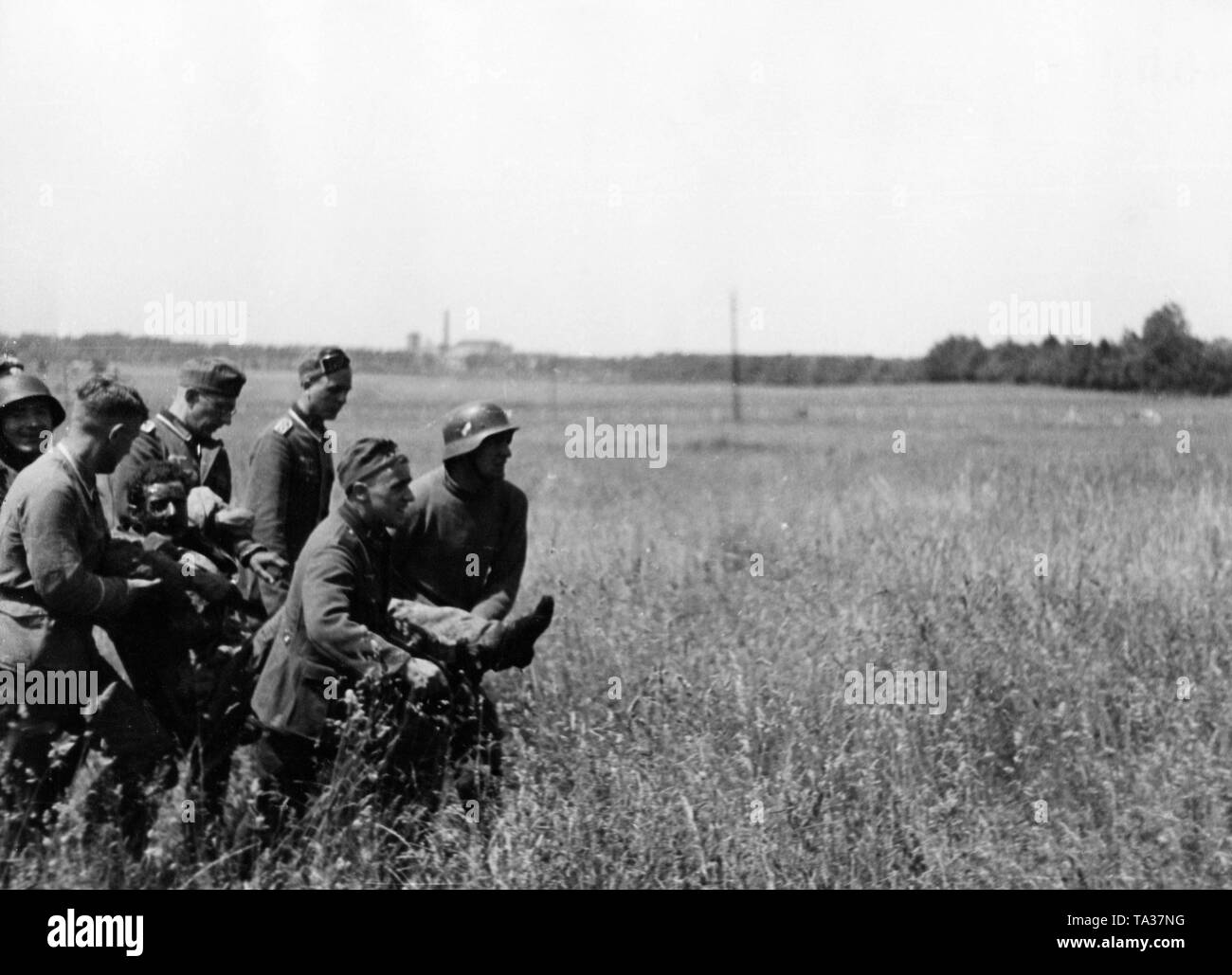 German soldiers are trying to drag a wounded man from the front lines ...