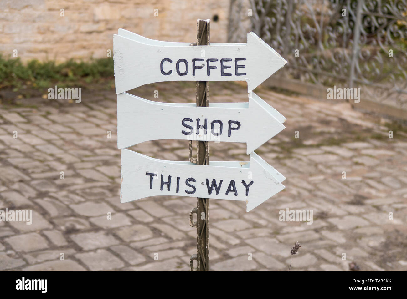 A sign indicating the direction of a coffee shop Stock Photo - Alamy