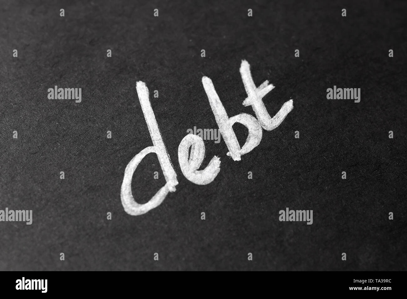 Word DEBT on dark background Stock Photo - Alamy