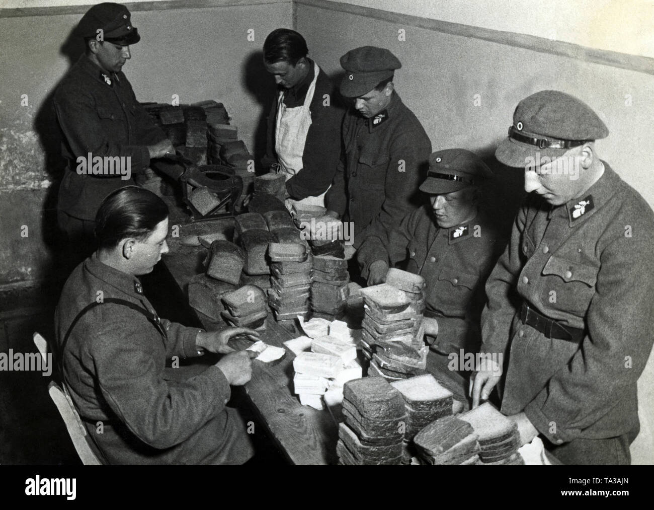 Members of the FAD prepare food for the workers and smear butter on ...