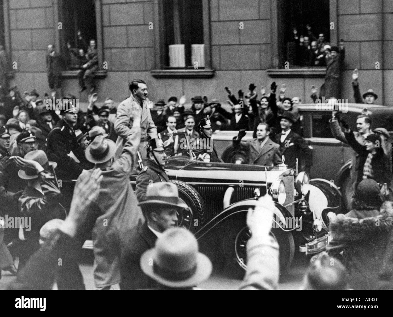 Adolf Hitler in the car driving through the Wilhelmstrasse in Berlin ...