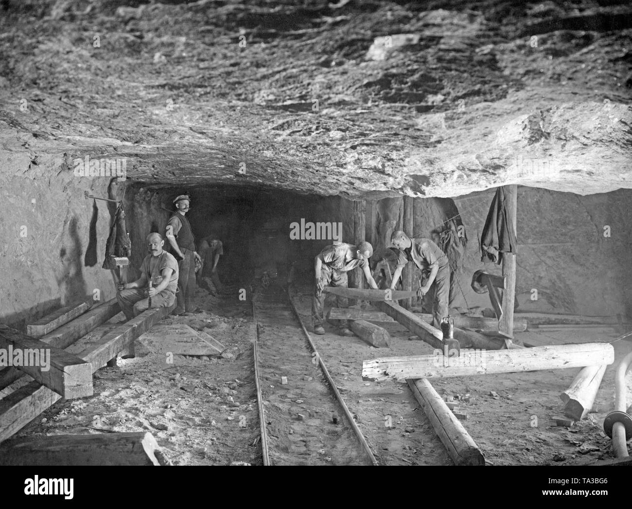 Workers prepare support beams for galleries in a salt mine Stock Photo ...