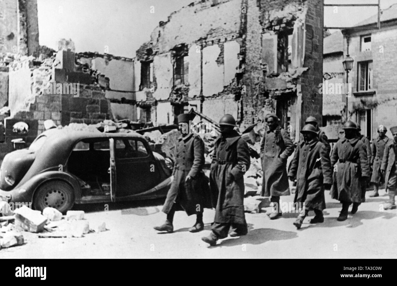 French soldiers, including members of North African troops, march under ...