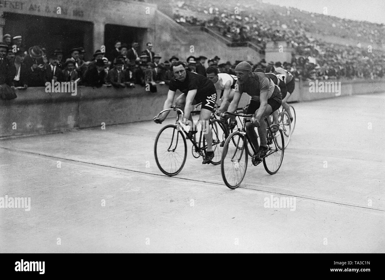 A group of bike riders cross the finish line in a cycling race on June ...