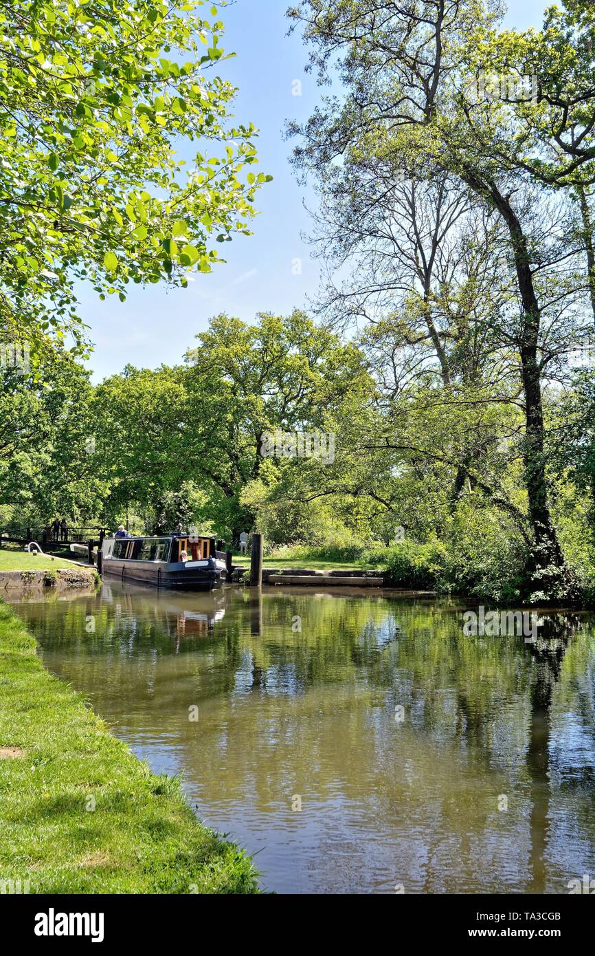 A narrow boat passing through Newark lock on the River Wey Navigation ...