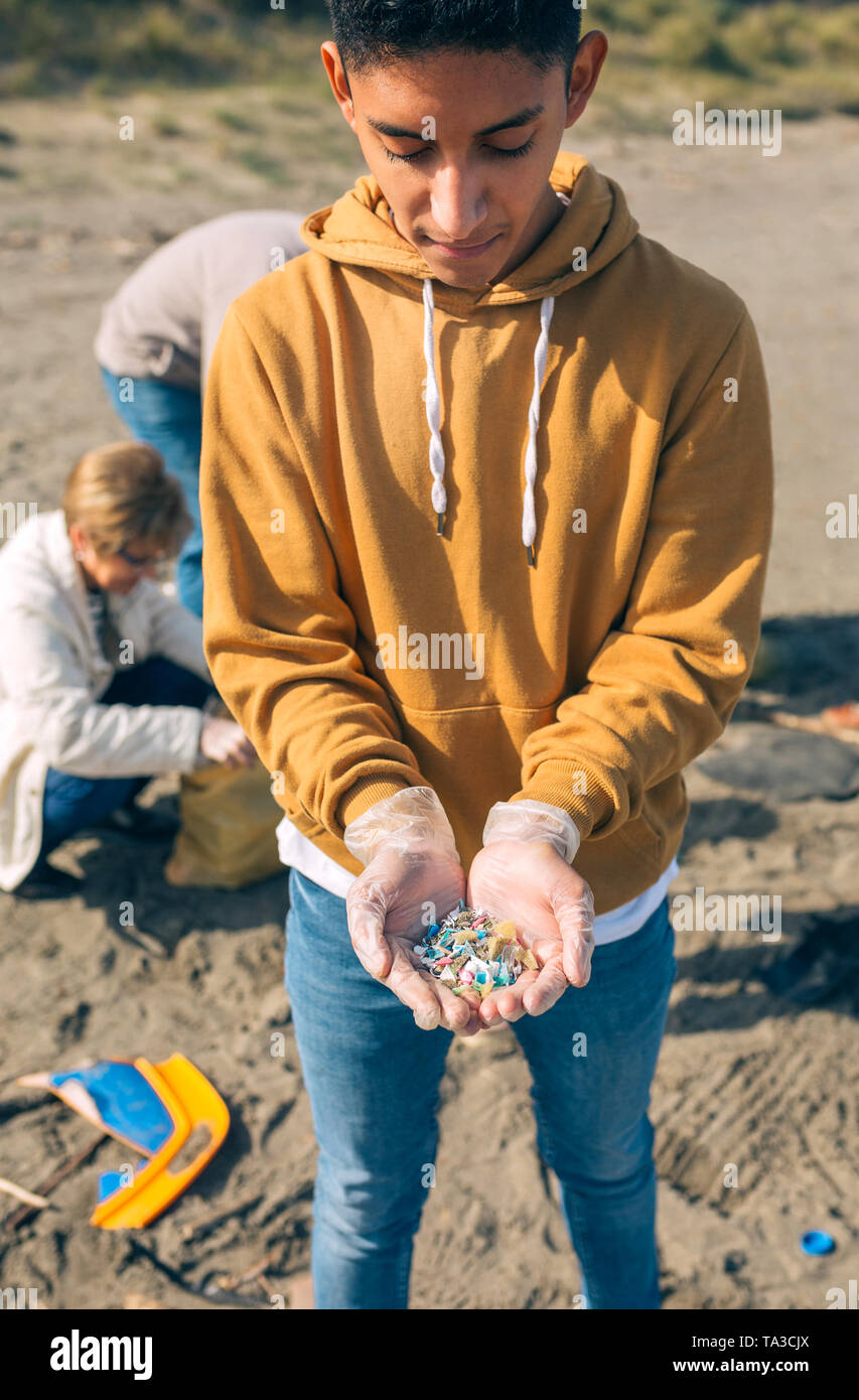 Young man showing microplastics Stock Photo - Alamy