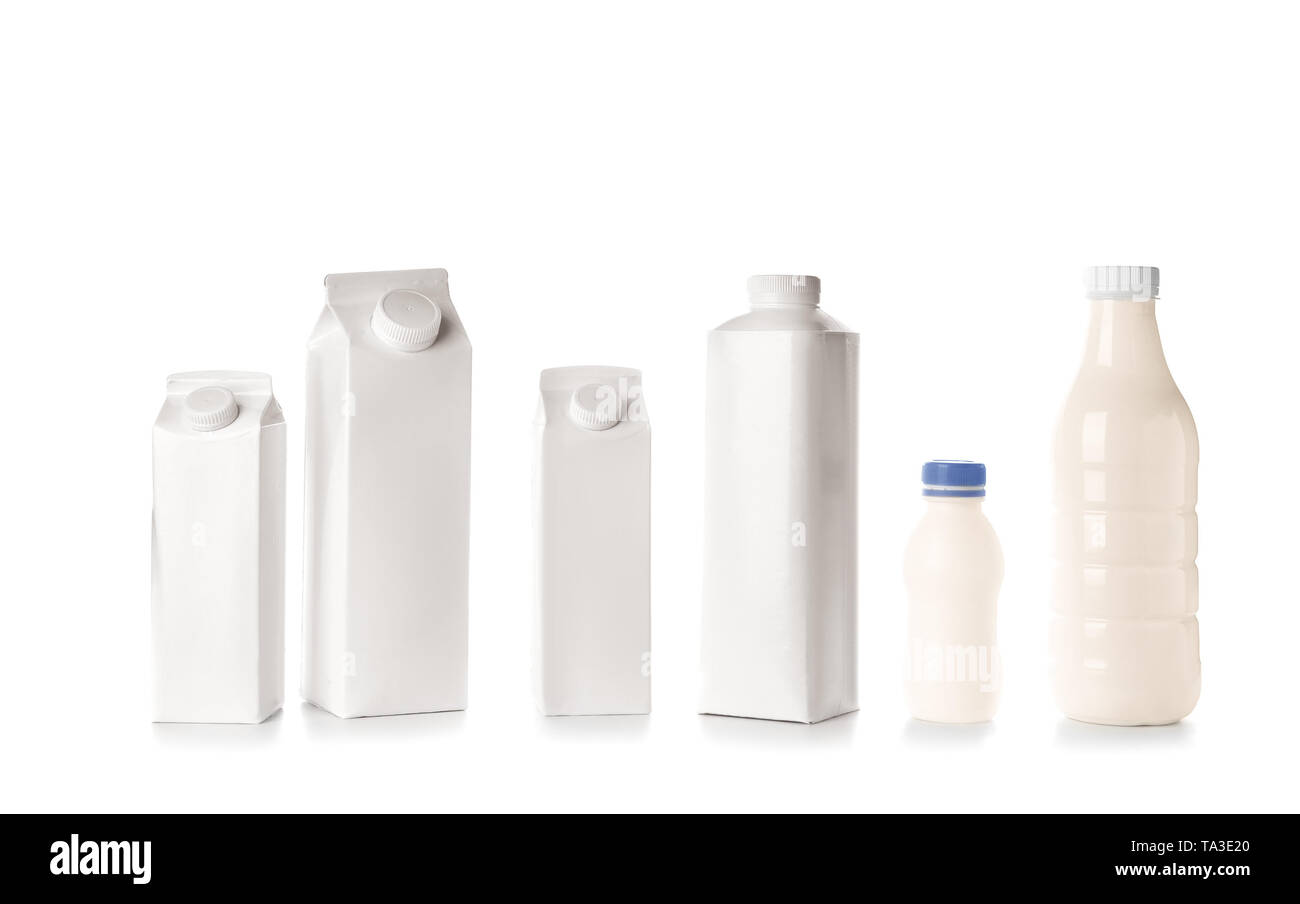 Different packs with milk on white background Stock Photo - Alamy