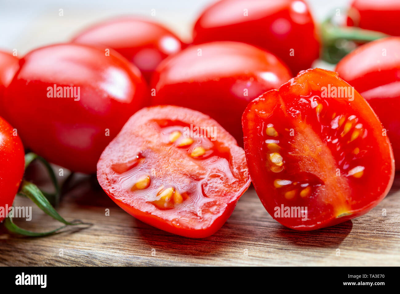 Vine of fresh ripe red cherry prunella tomates close up Stock Photo - Alamy