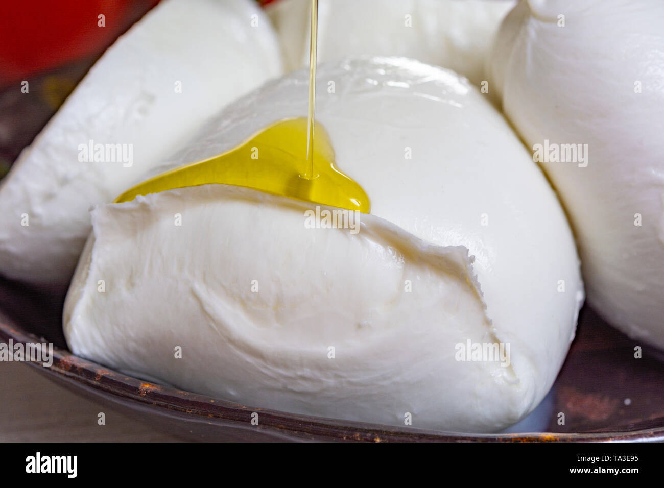 Balls and pieces of buffalo mozzarella, soft Italian scheese made from ...