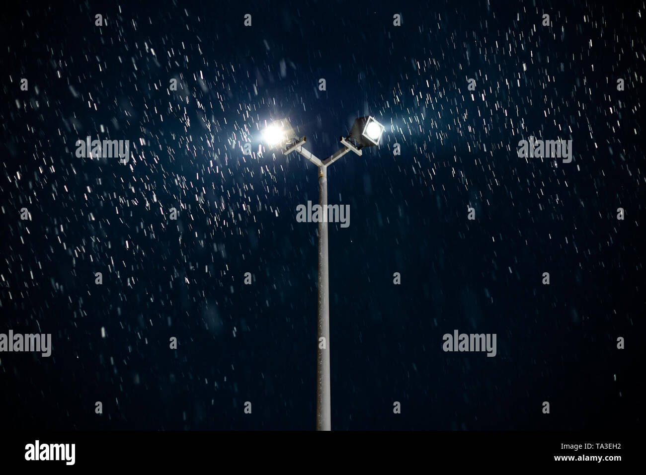 modern double light spot on lamp post at winter night snowfall Stock ...