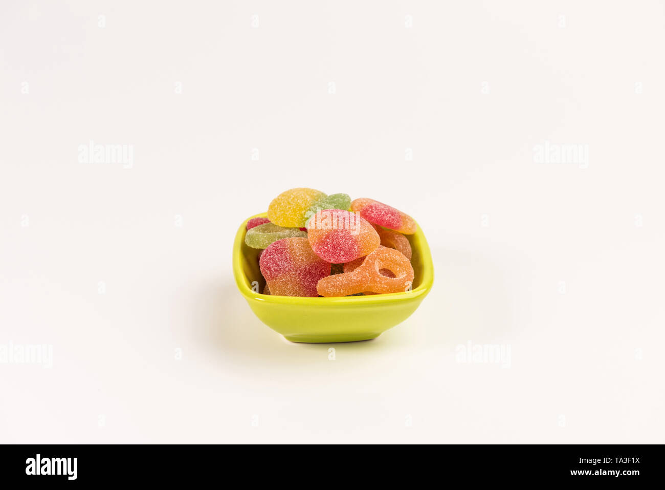 Small bowl with gummy candies isolated on white background Stock Photo ...