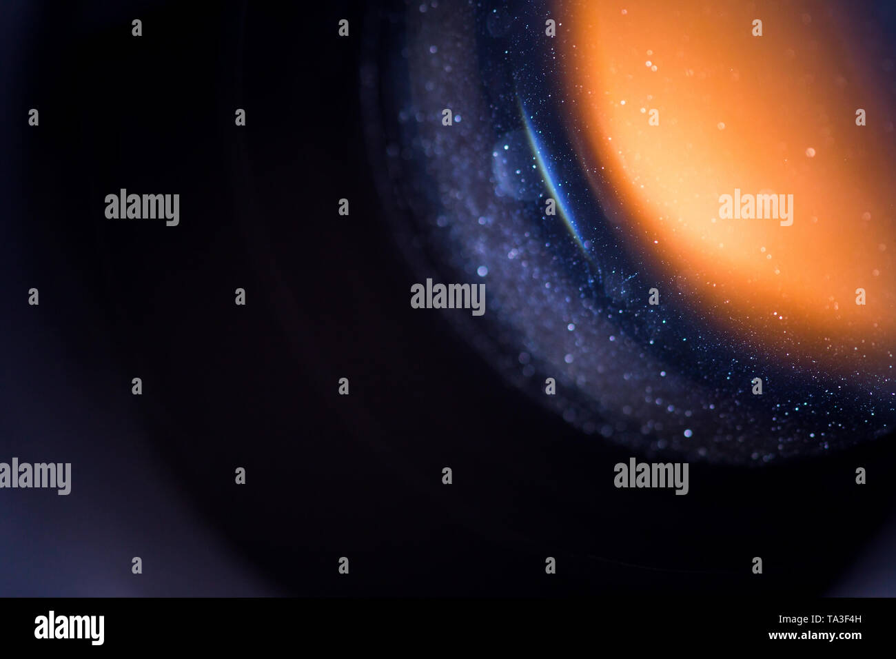 dust inside lens dark closeup background Stock Photo - Alamy