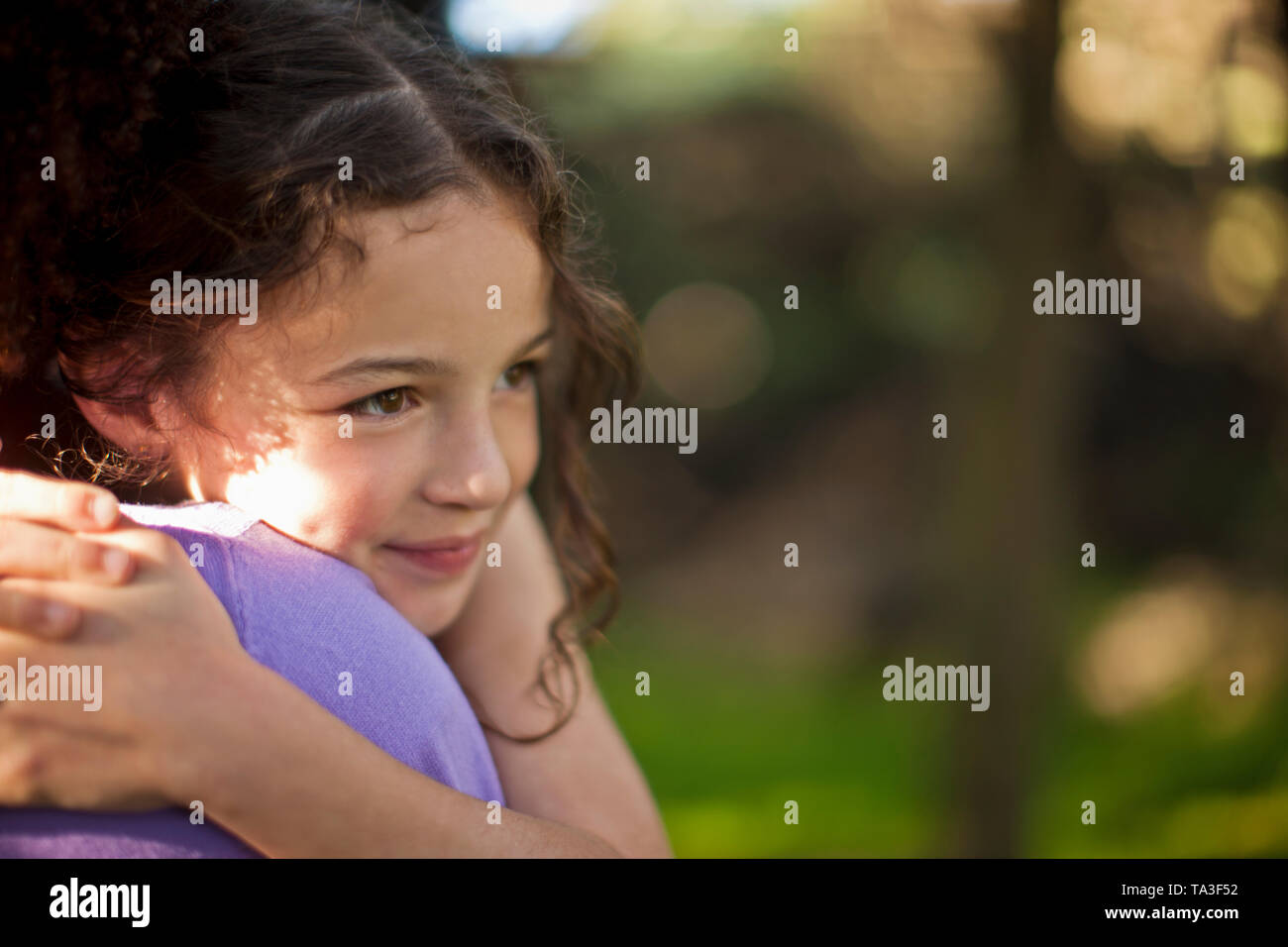 Content young girl being hugged Stock Photo - Alamy