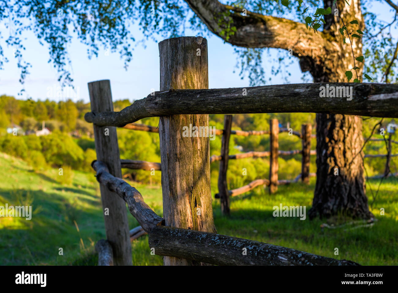 rustic view with log fence on hill Stock Photo - Alamy