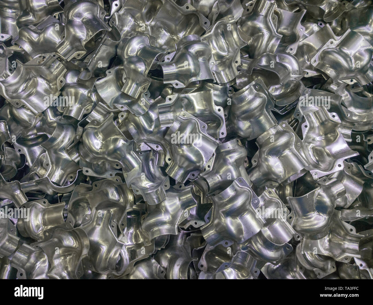 Shiny formed aluminium parts background Stock Photo - Alamy
