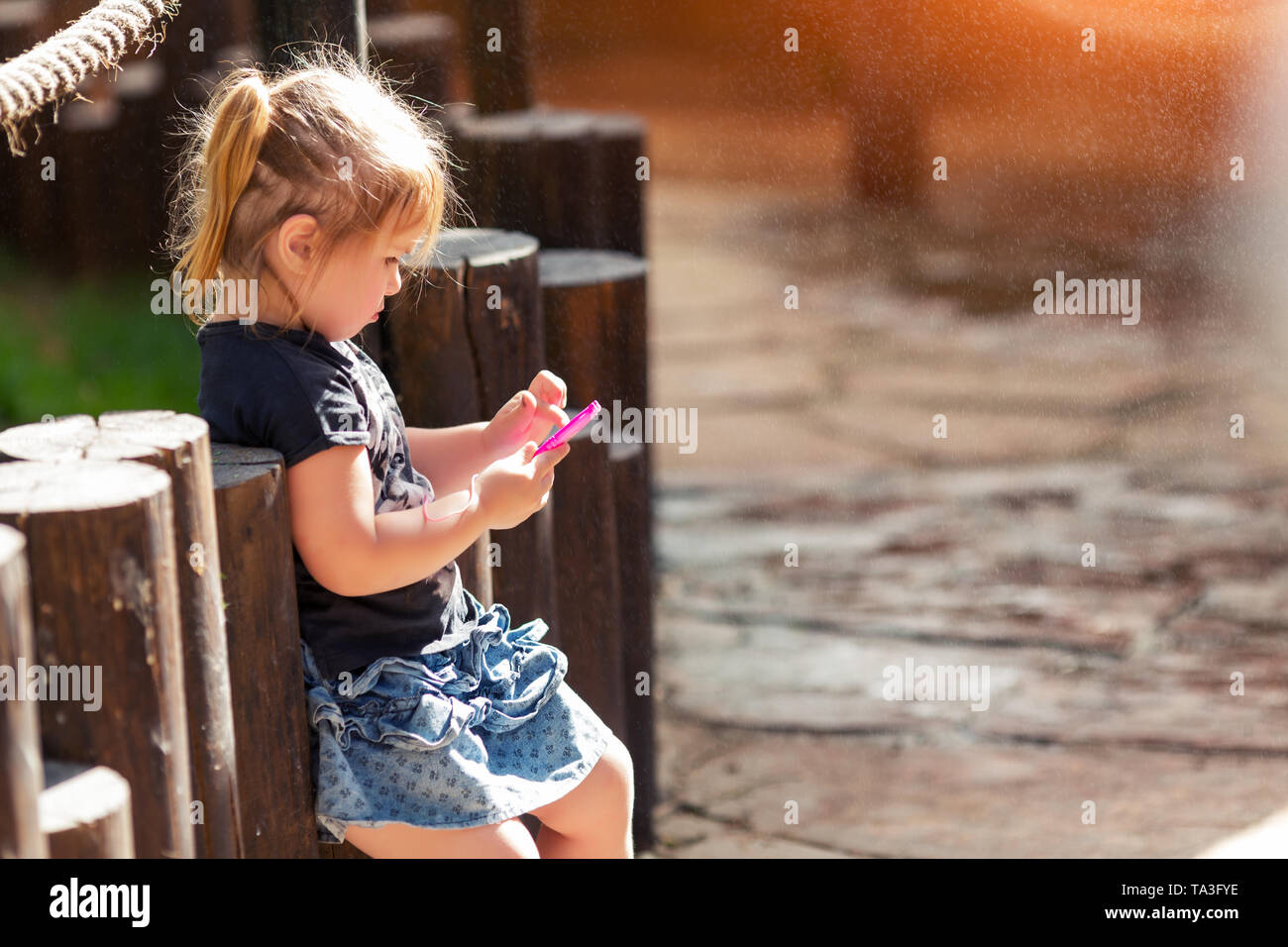Little girl talking on a toy mobile phone Stock Photo - Alamy