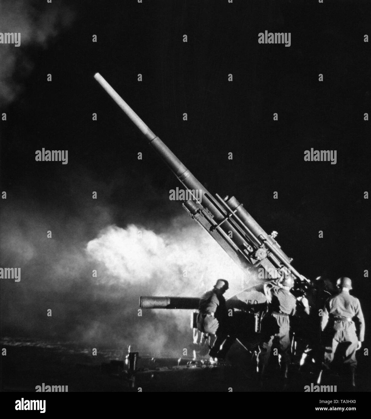 Wehrmacht soldiers, anti-aircraft artillery, shooting with an antiaircraft gun of the type 8.8 ...