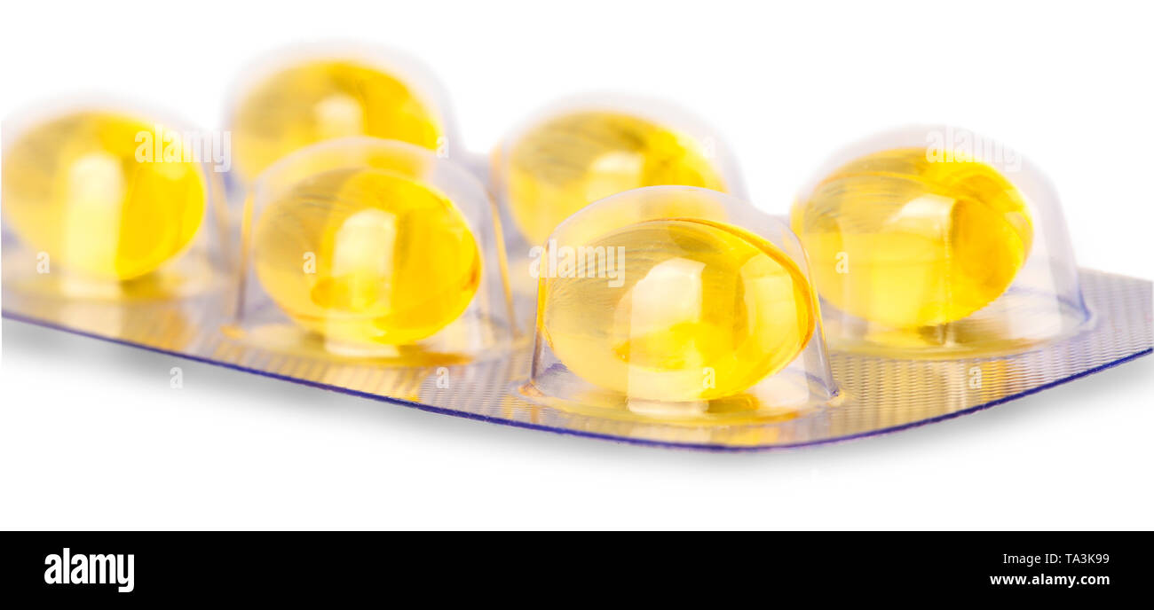 Yellow color soft gelatin capsule on white background (Concept of ...