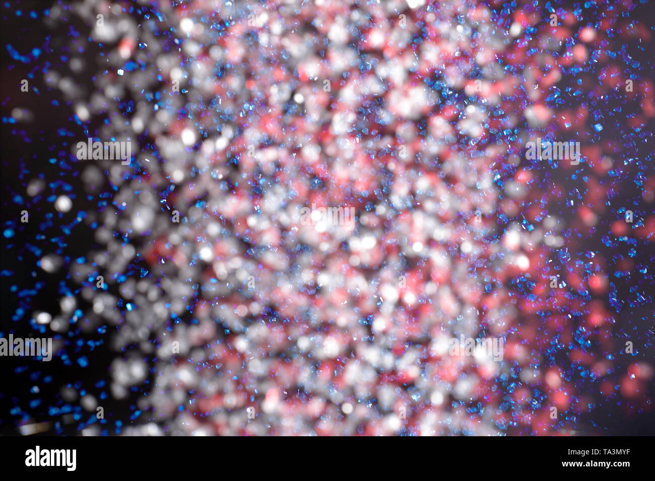 Mix of falling red, white, and blue sprinkles against a black ...