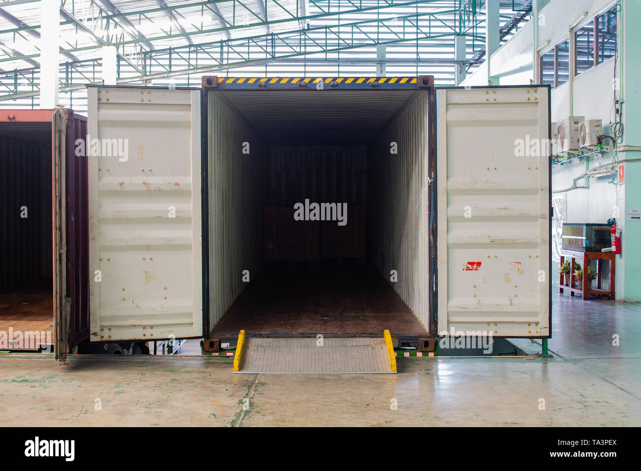 The container inside warehouse on shipment area Stock Photo - Alamy