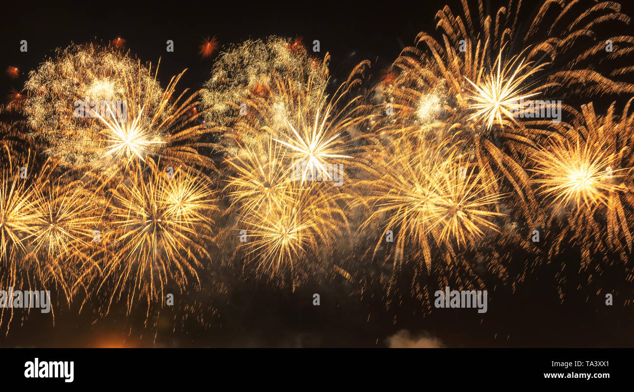 Gold color firework display for celebration Stock Photo - Alamy