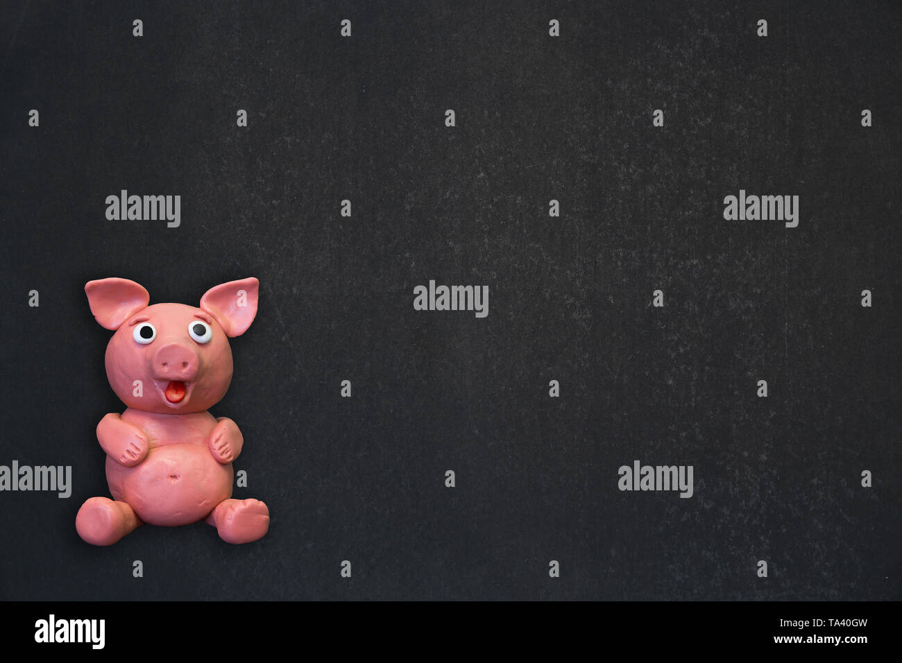 Plasticine clay handmade pig on black background Stock Photo - Alamy