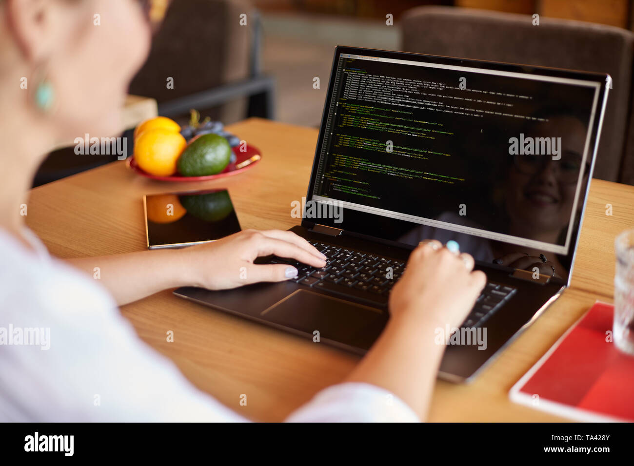 Back View Over The Shoulder Shot Of Developer Programmer With Laptop Program Code And Script