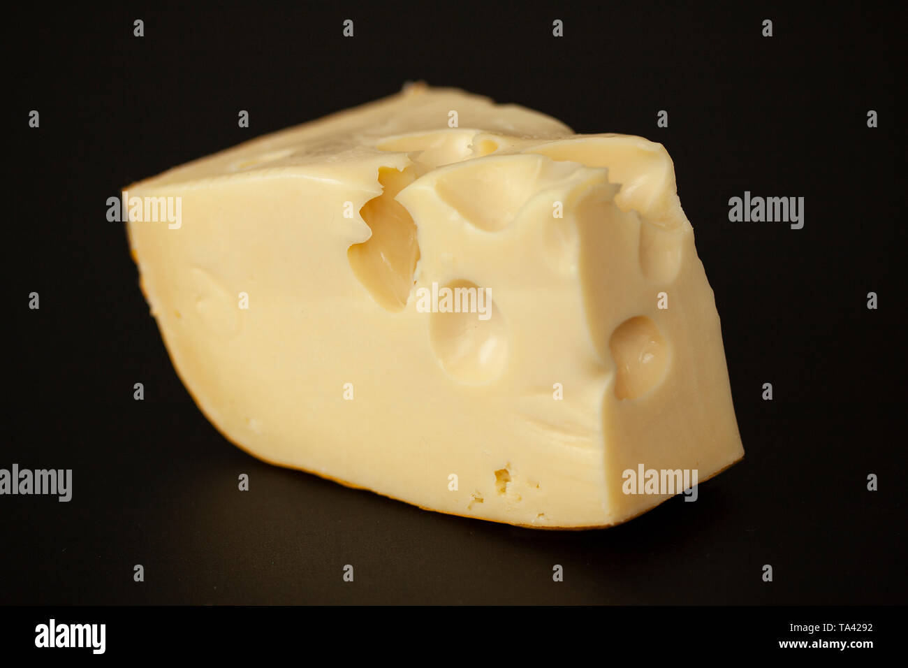 Big chunk of Swiss Emmental cheese isolated on black Stock Photo - Alamy