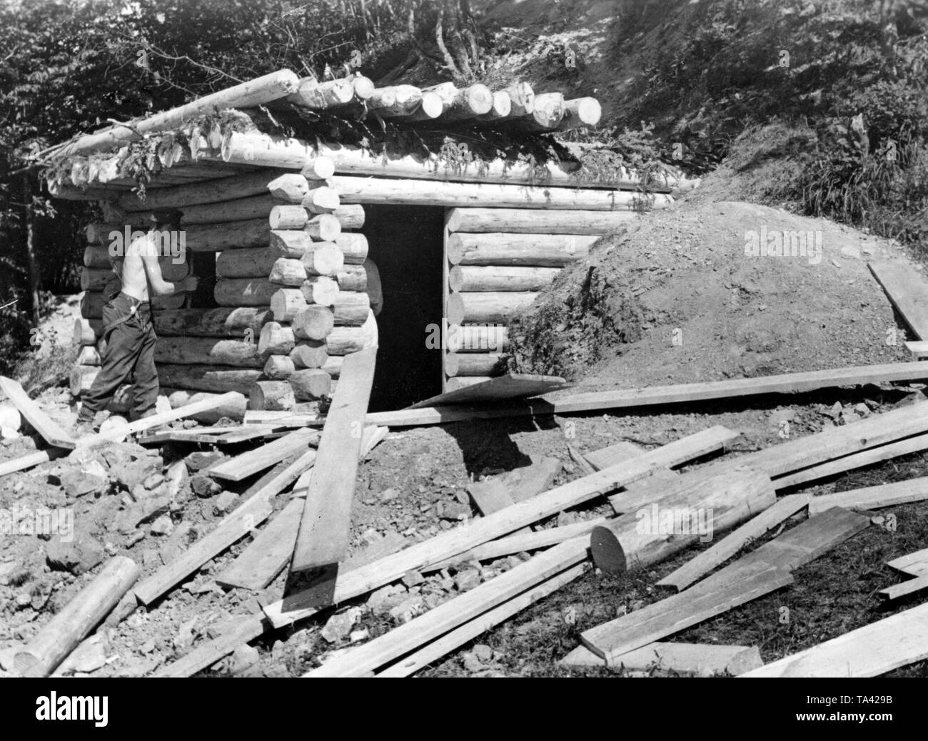 A German soldier builds a log cabin in a slope. Presumably, this PK ...