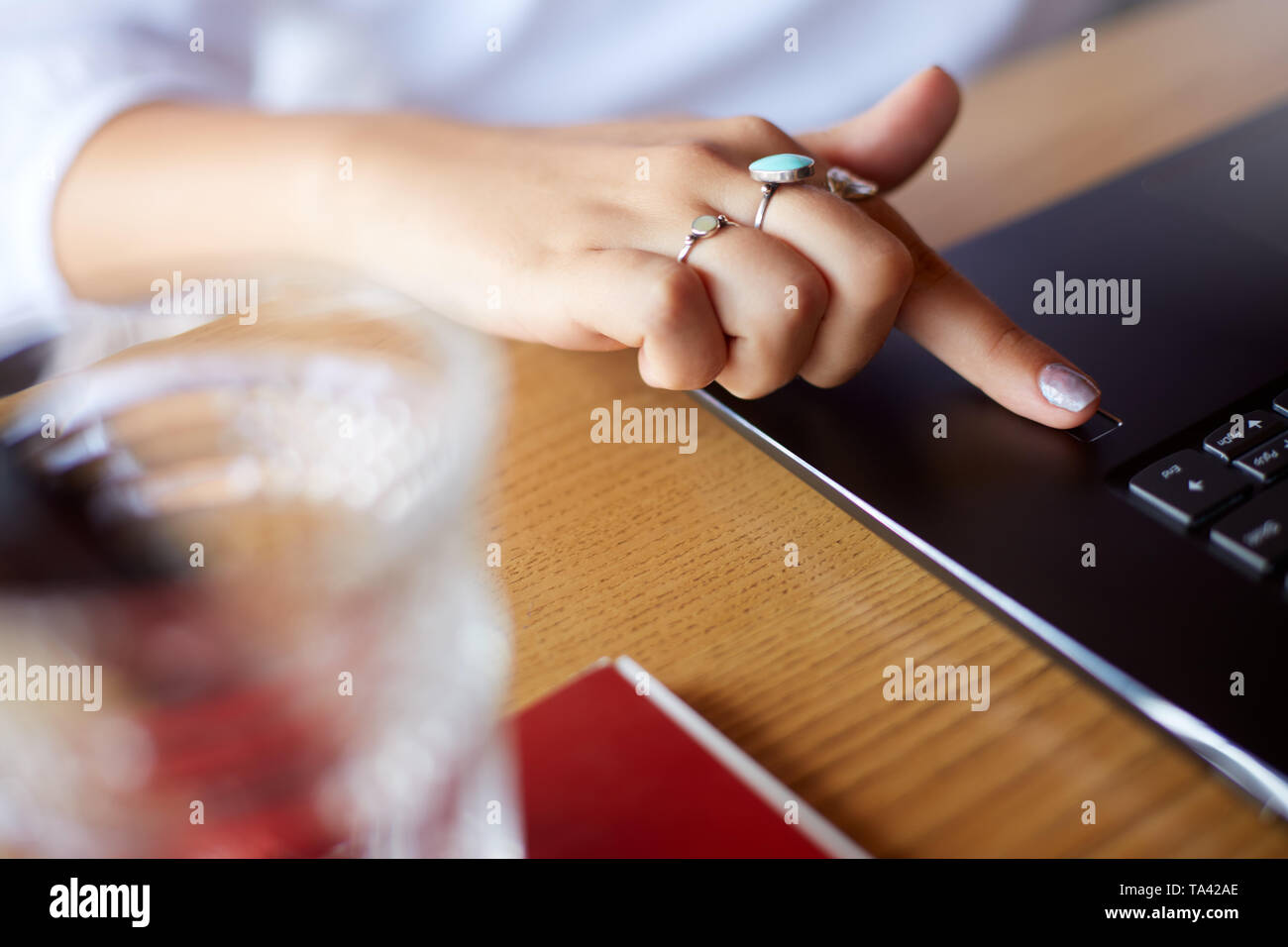 Close up photo of woman touching laptop fingerprint sensor with her ...
